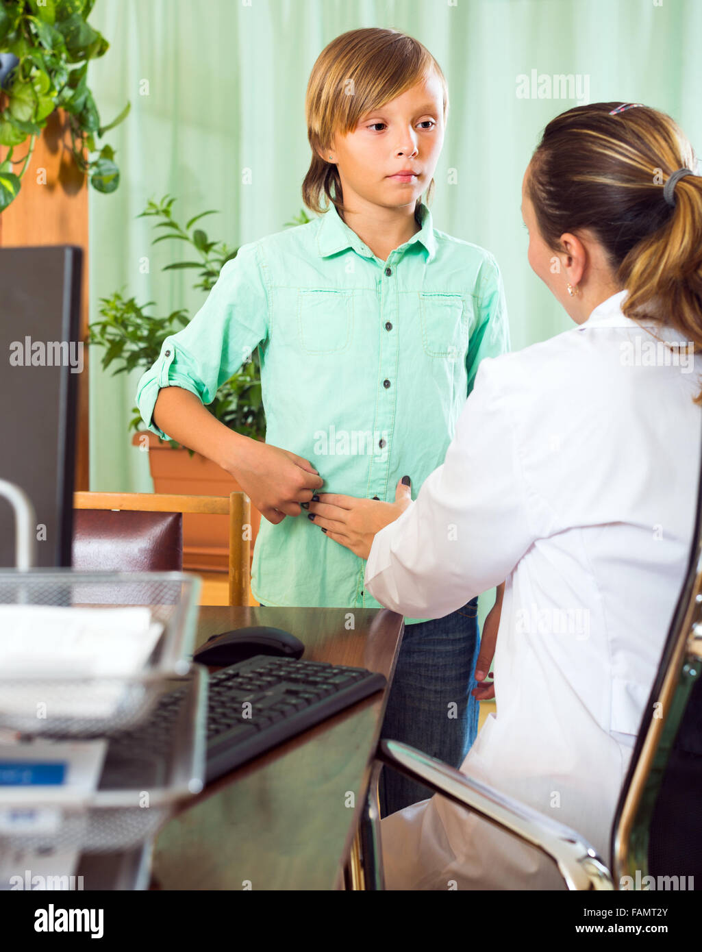 Teenager boy patient complaining of pain in stomach side to doctor in ...