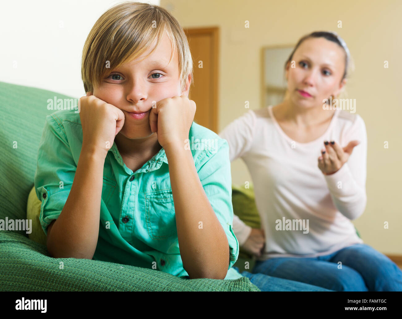 middle-aged woman berating teenage son at home Stock Photo - Alamy