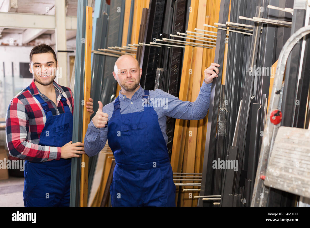 Two positive workers posing in PVC shop Stock Photo - Alamy