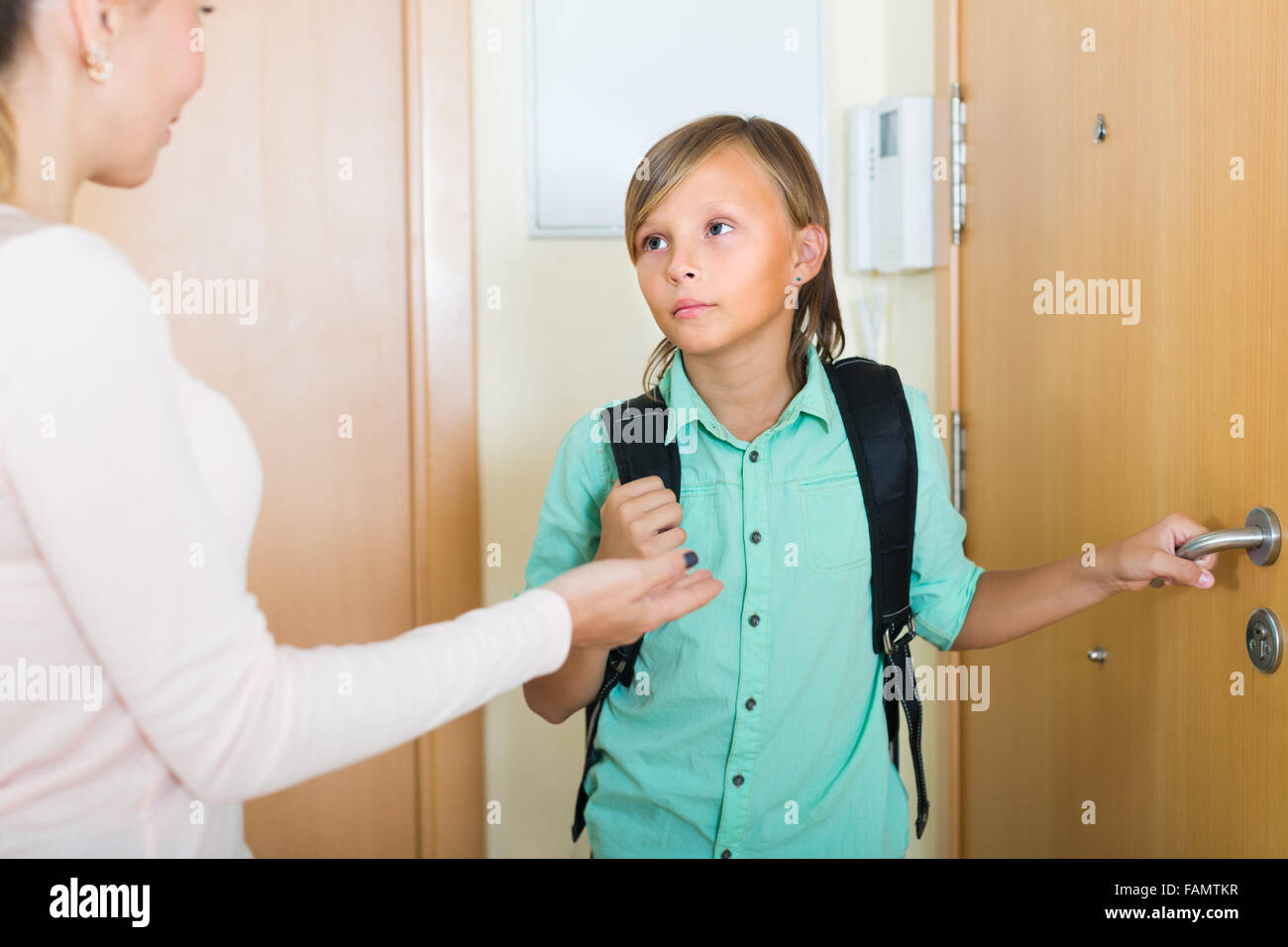 Optimistic mature woman lecturing boy before he goes to school Stock ...