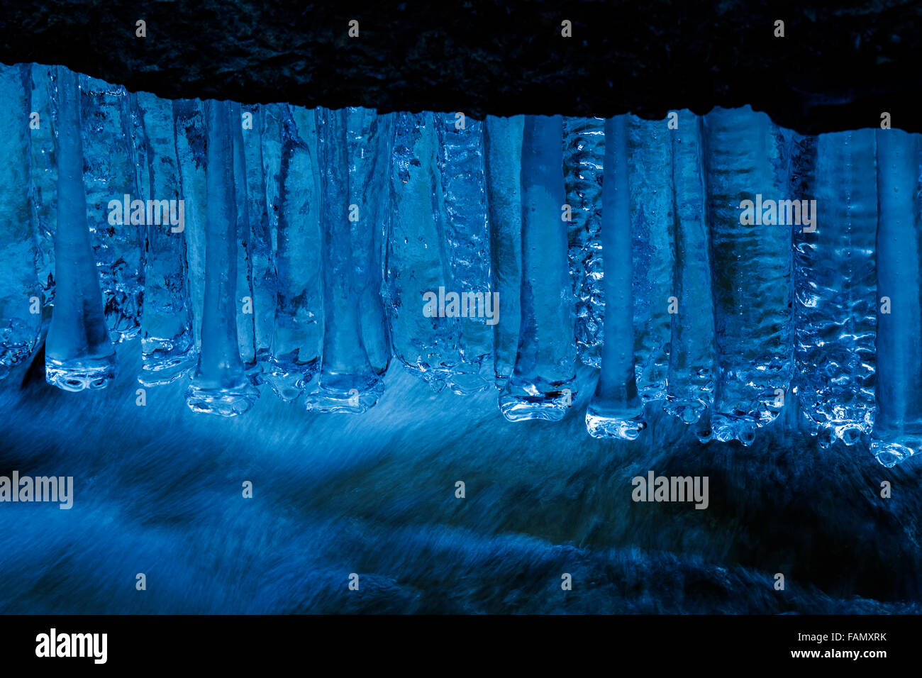 Frozen waterfall with blue ice in winter Stock Photo - Alamy