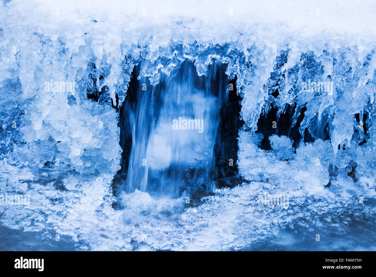 Frozen waterfall with blue ice in winter Stock Photo - Alamy
