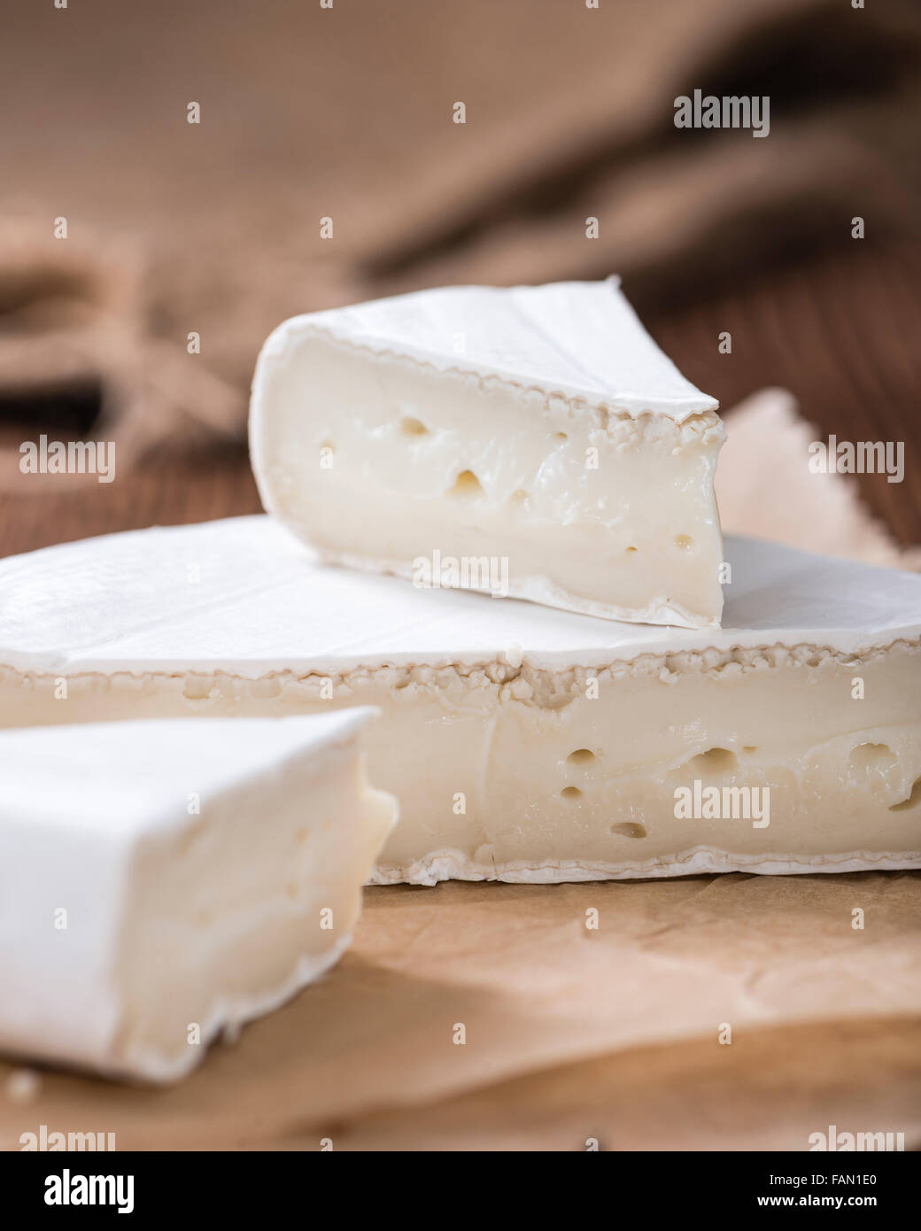 Pieces of Camembert on vintage wooden background (close-up shot Stock ...