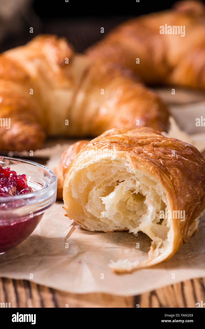 Fresh baked Croissants (close-up shot) on wooden background Stock Photo ...