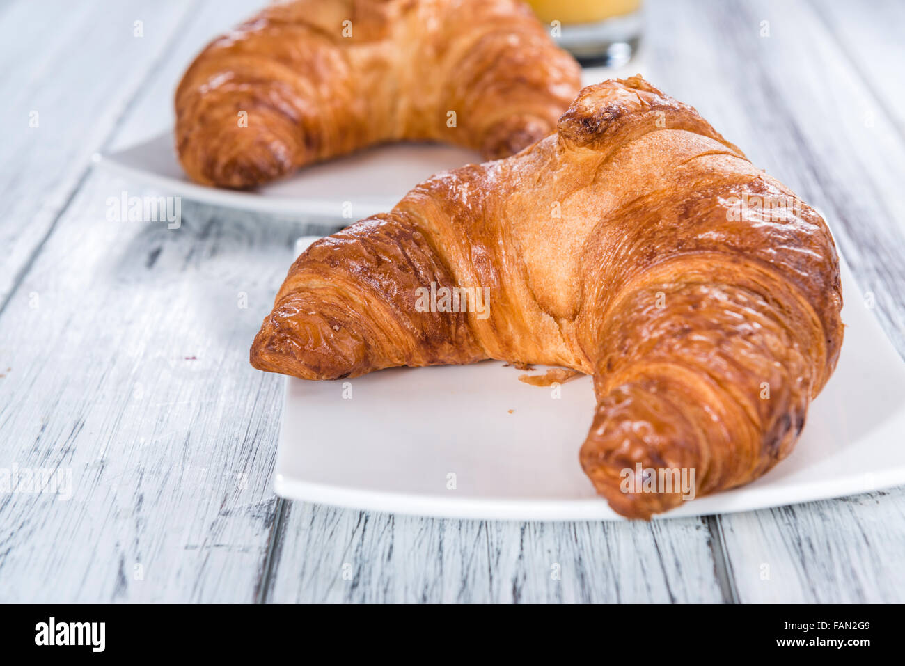 Fresh baked Croissants (close-up shot) on wooden background Stock Photo ...