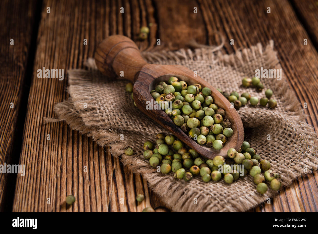 Portion of green Peppercorns (close-up shot) on wooden background Stock ...