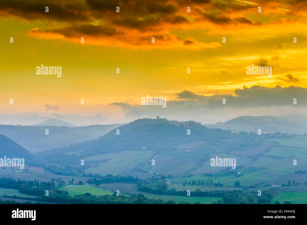 rolling hills and agricultural land near town of Monticchiello at dawn ...