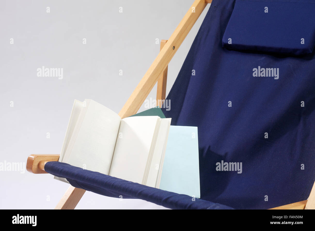 Deck chair made of wooden frame and sky blue canvas Stock Photo - Alamy