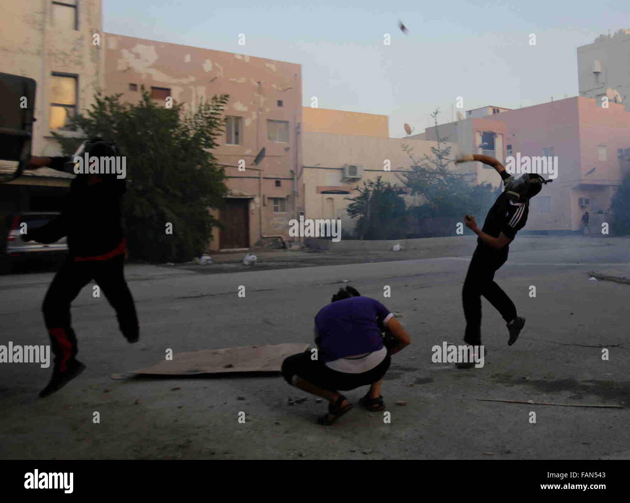Sitra, Bahrain. 1st Jan, 2016. Protesters throw stones at riot police ...