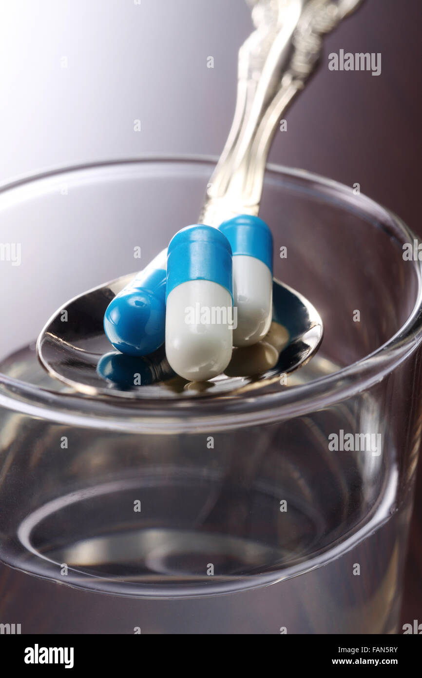 medicine and a glass of water Stock Photo - Alamy