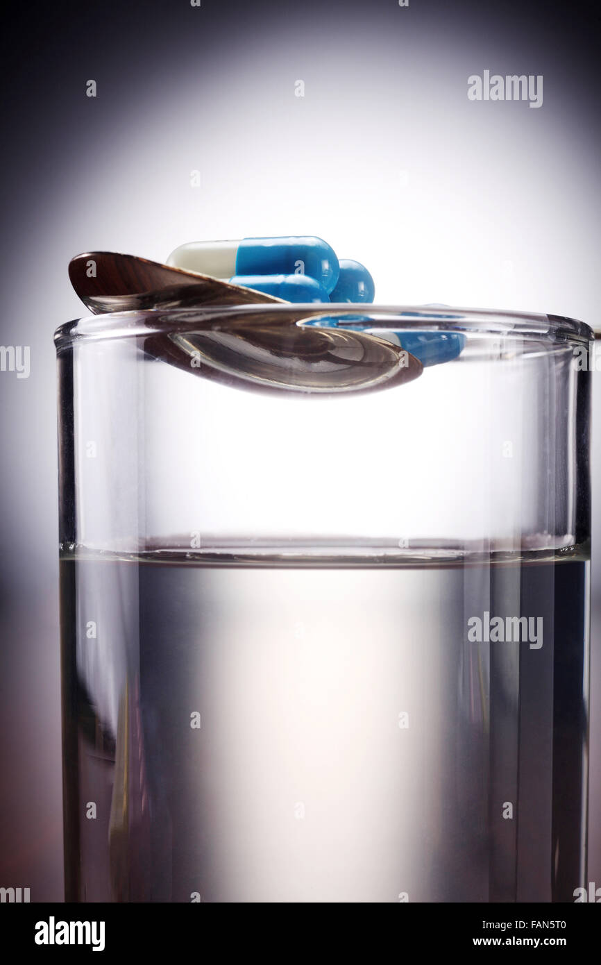 medicine and a glass of water Stock Photo - Alamy
