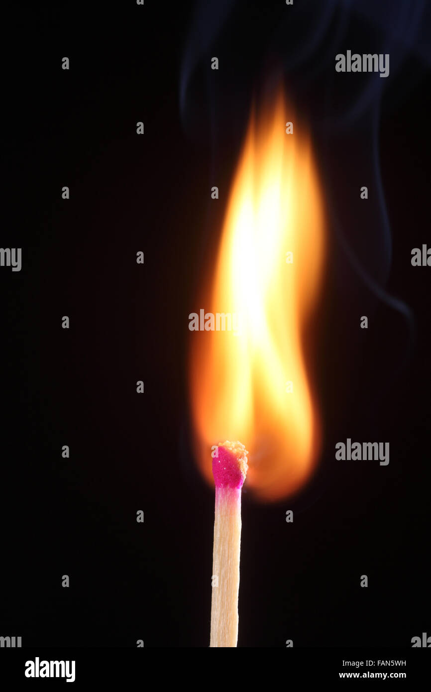 Match ignited on the black Stock Photo - Alamy