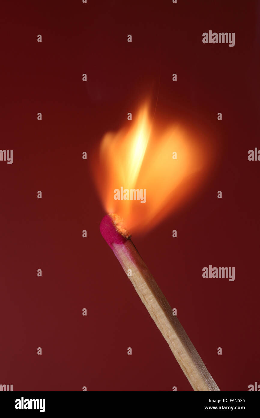 Match ignited on the black Stock Photo - Alamy