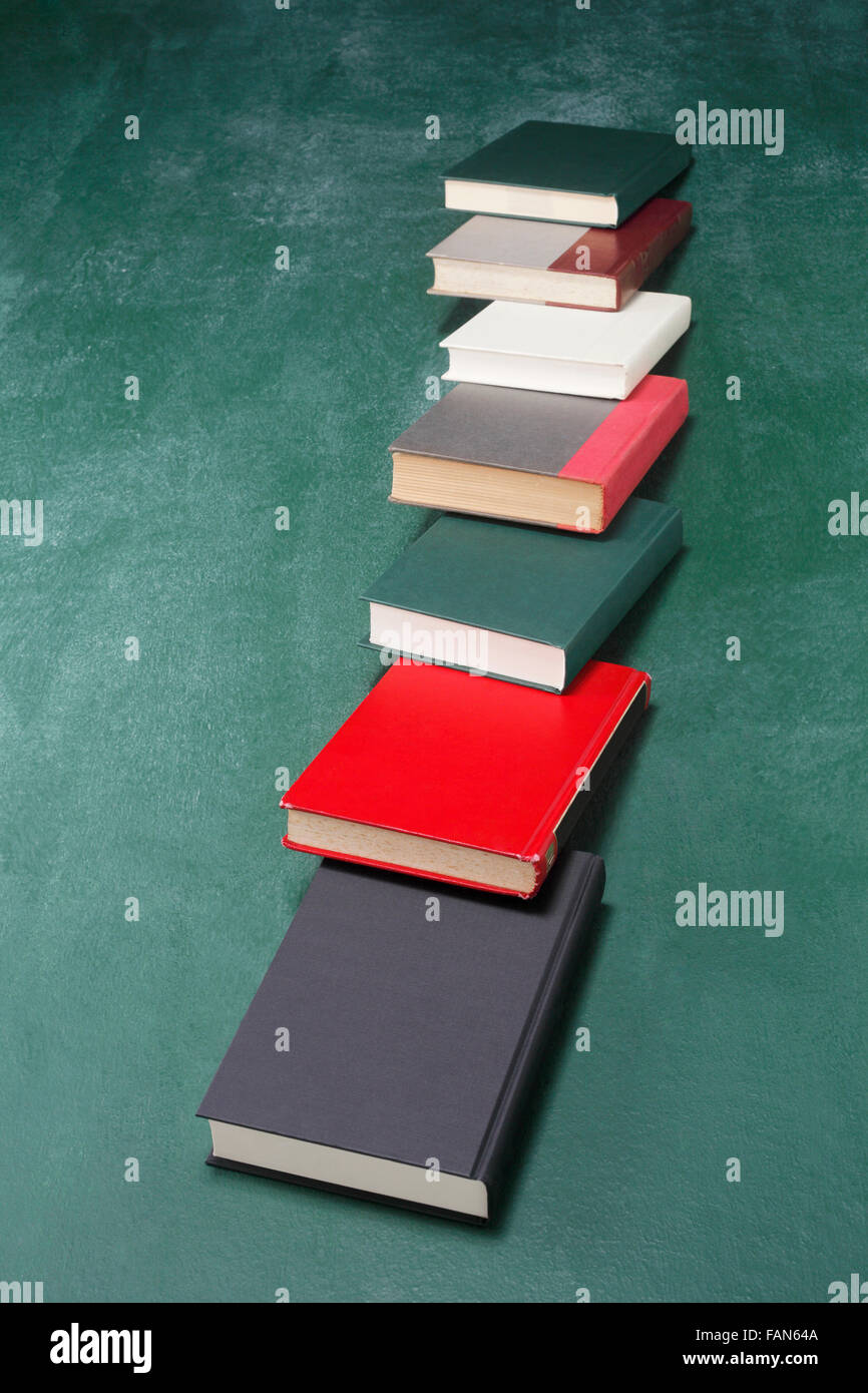 book in a row on the green background Stock Photo - Alamy