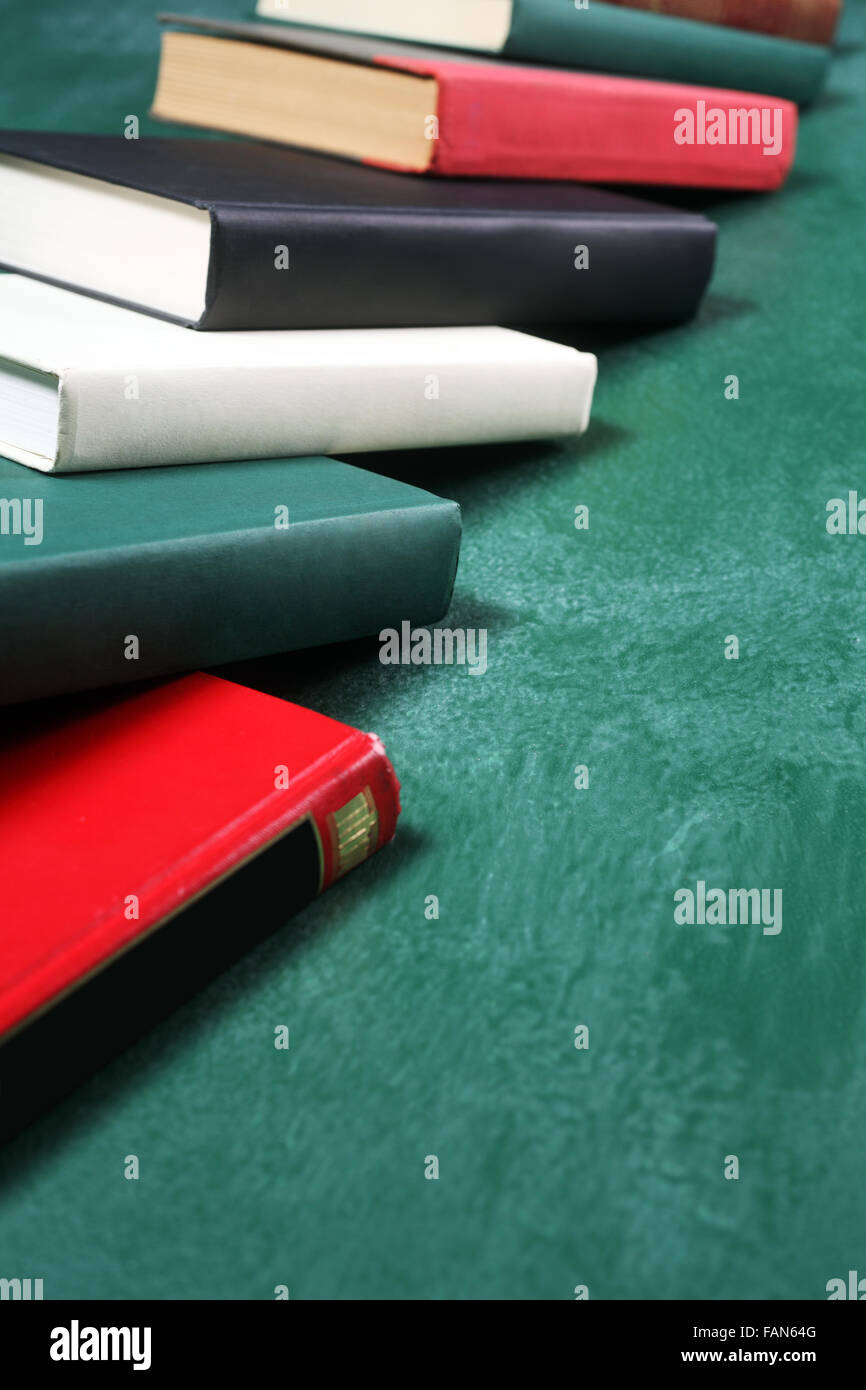 book in a row on the green background Stock Photo - Alamy