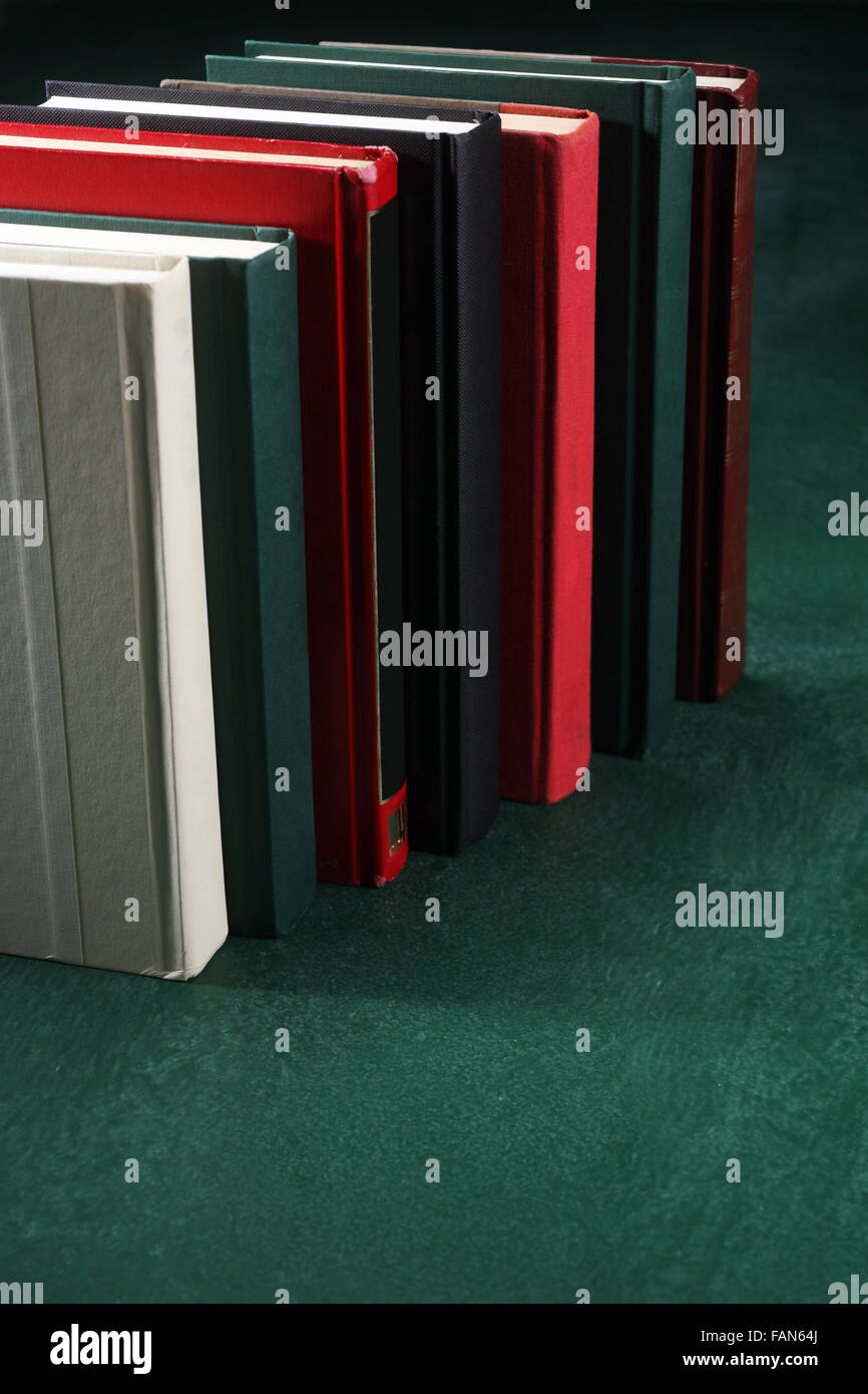 book in a row on the green background Stock Photo - Alamy