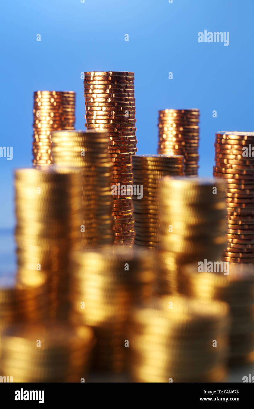 Stacks of gold coins on color background Stock Photo - Alamy