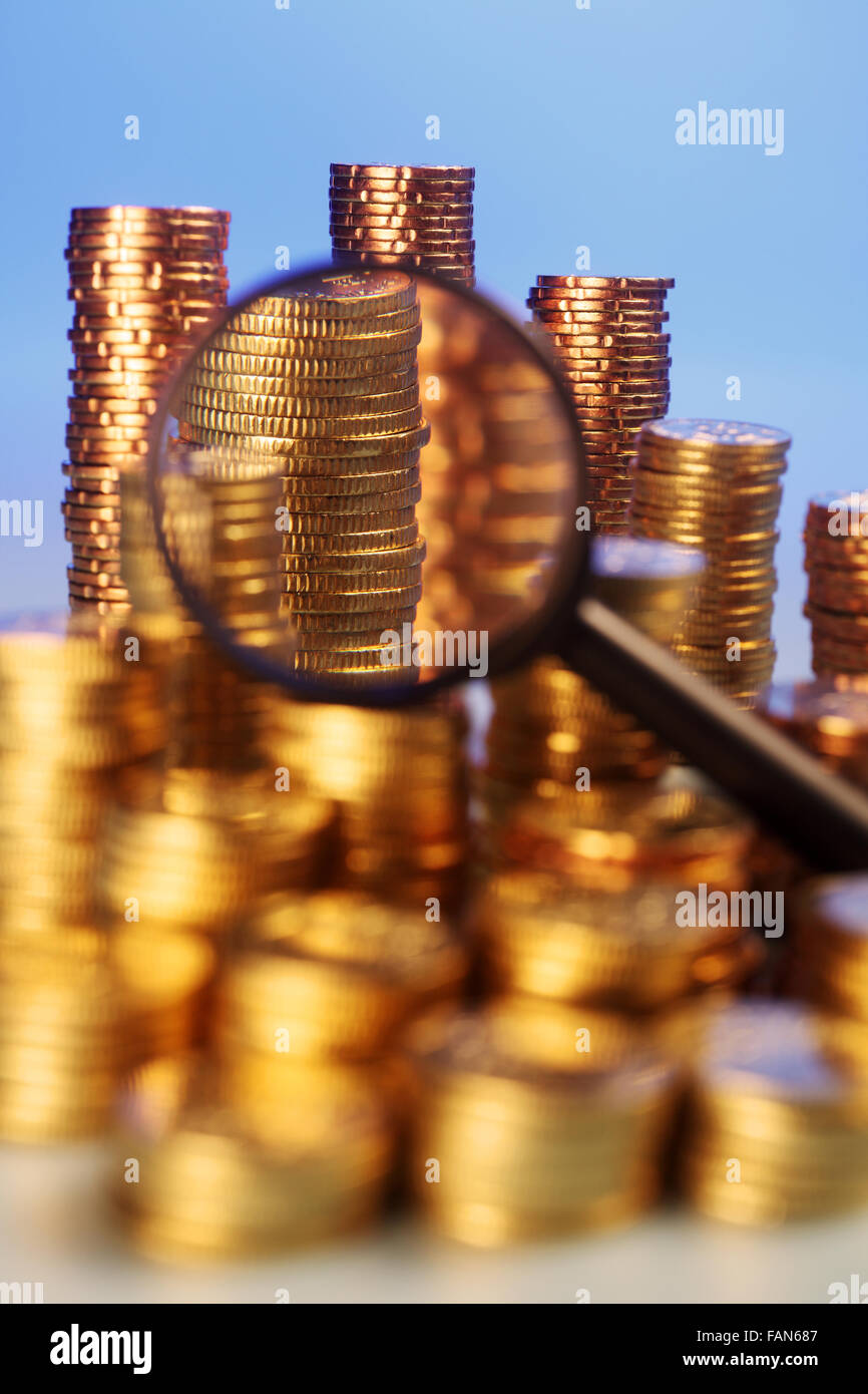 coins and magnifying glass Stock Photo - Alamy
