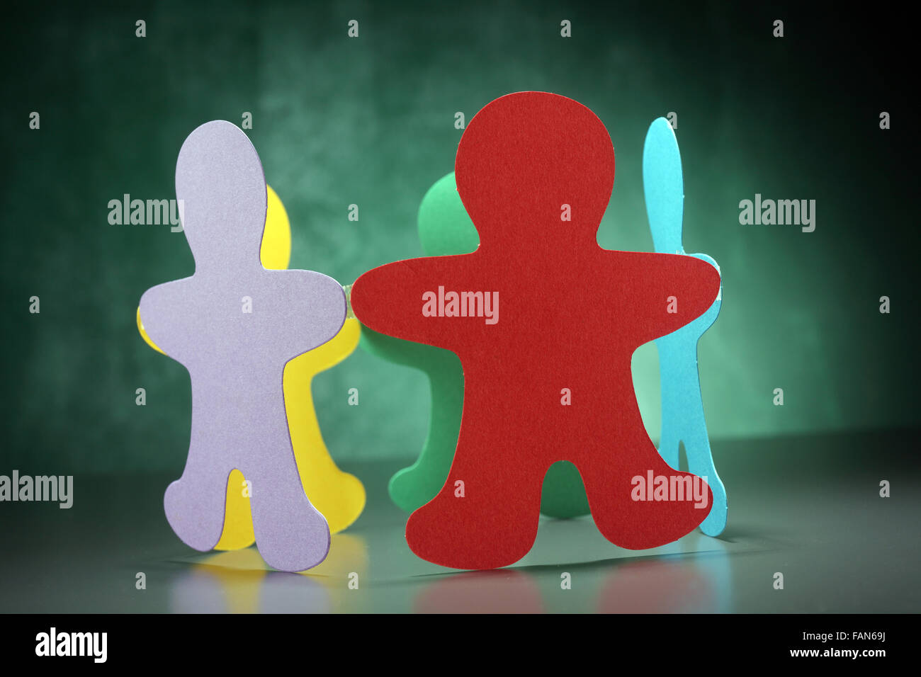 red, yellow, green & purple and blue cut out figures forming Stock ...