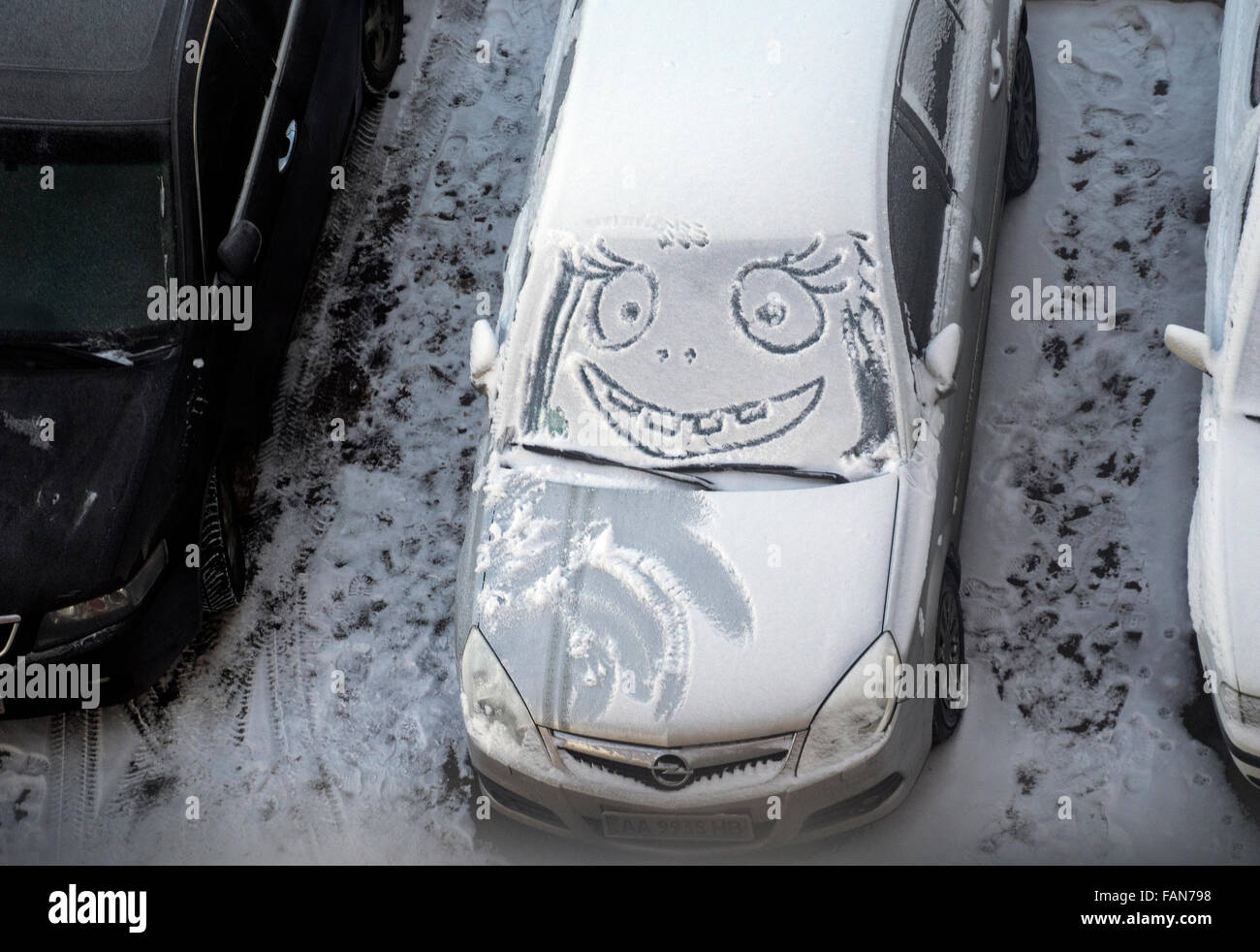 Funny face on snow covered car Stock Photo - Alamy