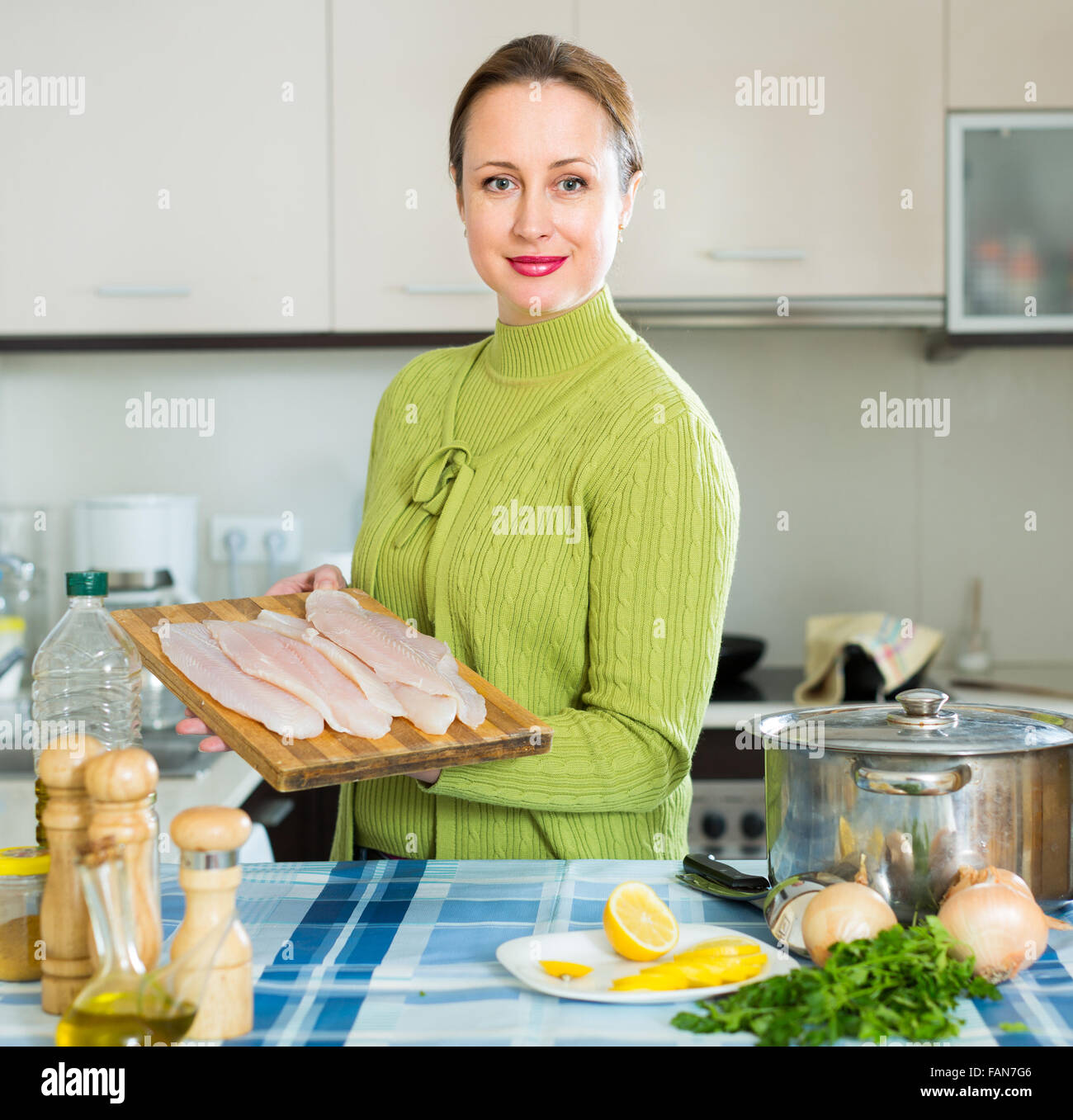 Woman cooking whitefish hi-res stock photography and images - Alamy