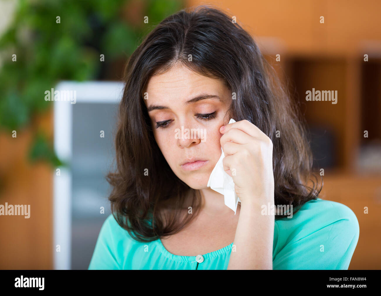 Young brunette woman crying at her home closeup Stock Photo - Alamy