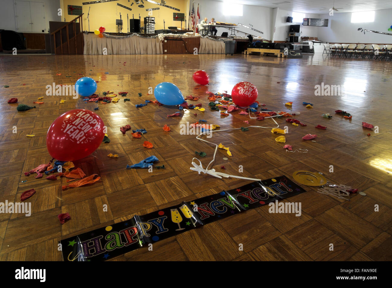 Auditorium floor littered with balloons and party favors left over from ...