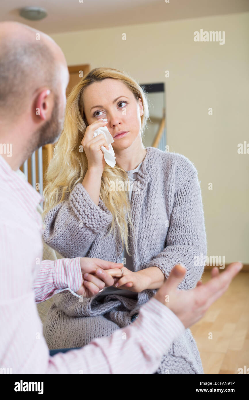 Man tries reconcile with woman in home. Focus on girl Stock Photo - Alamy