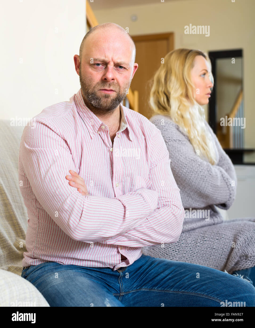 Sad husband thinking of divorce after a quarrel with his wife that is ...