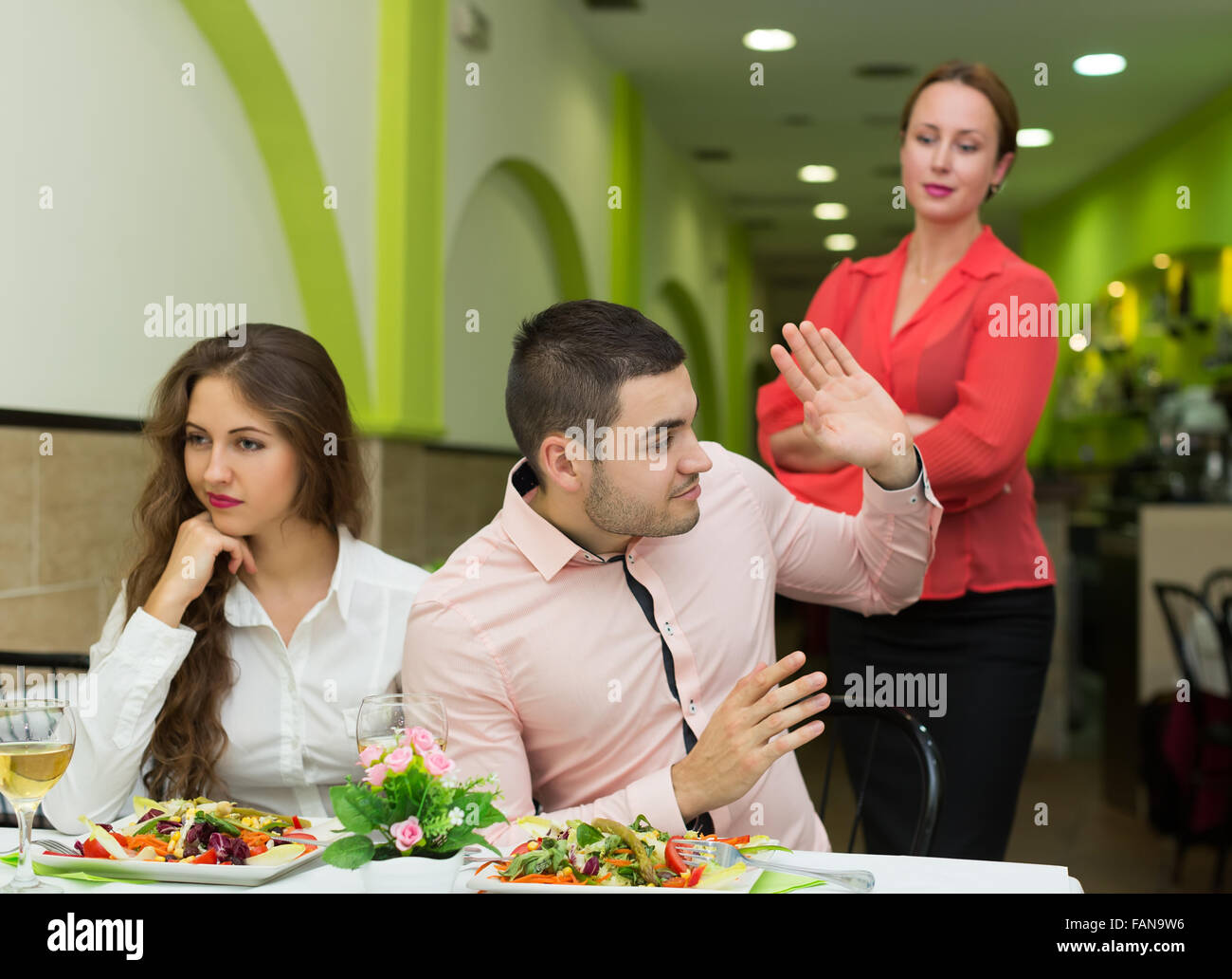 Unpleased client talking with manager in restaurant Stock Photo - Alamy