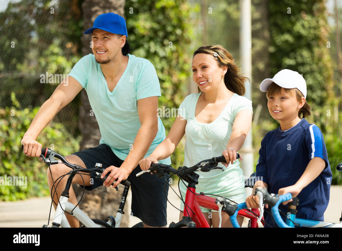 family of three cycling across city in summer day Stock Photo - Alamy