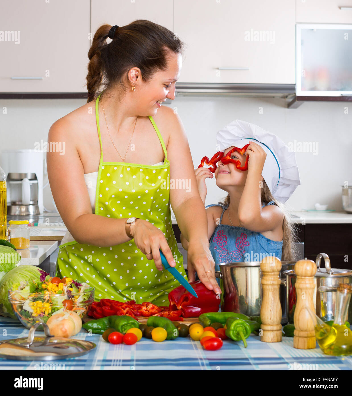 Small girl helping mother soup hi-res stock photography and images - Alamy