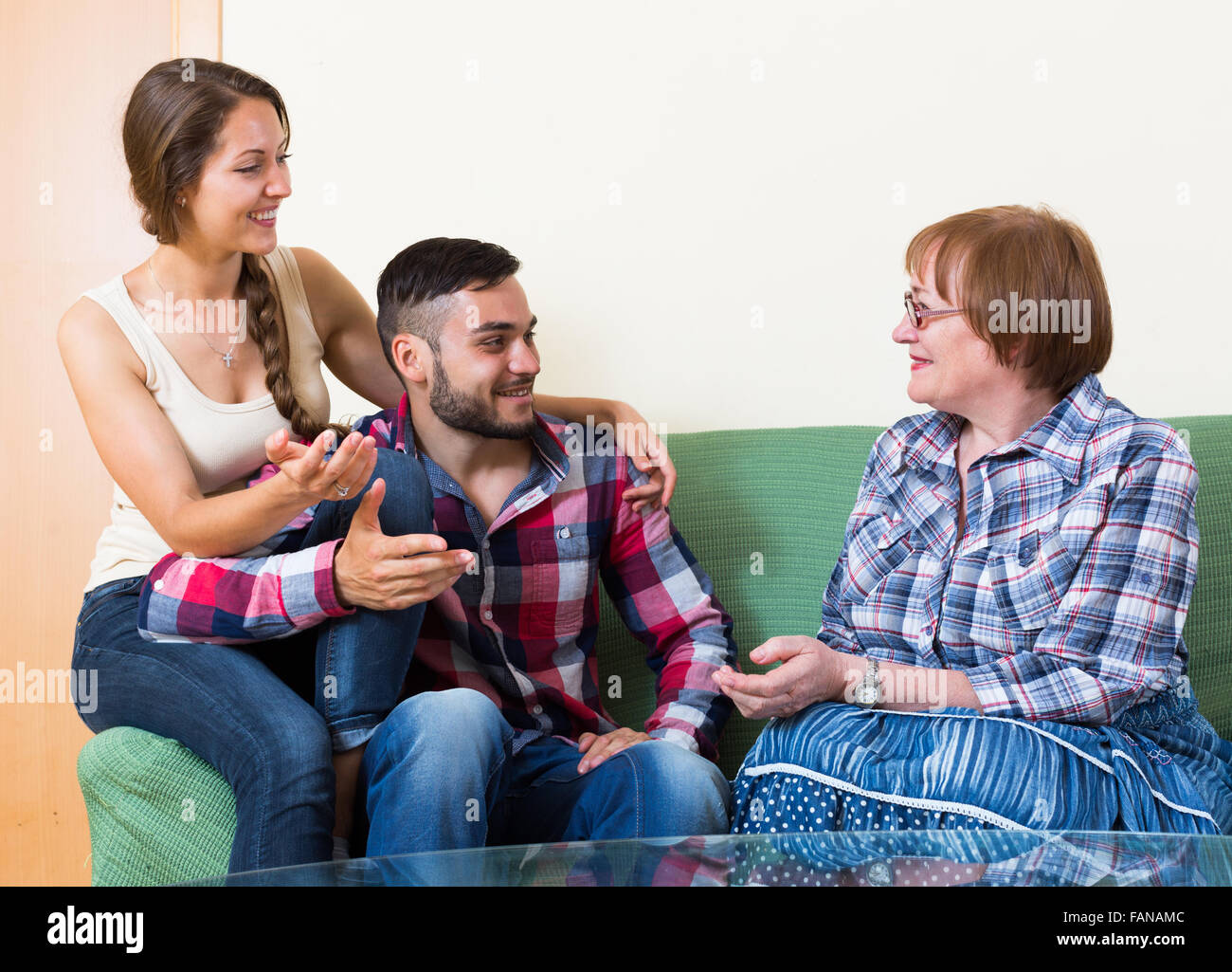 Adult children talking with happy mother at the parental home Stock ...
