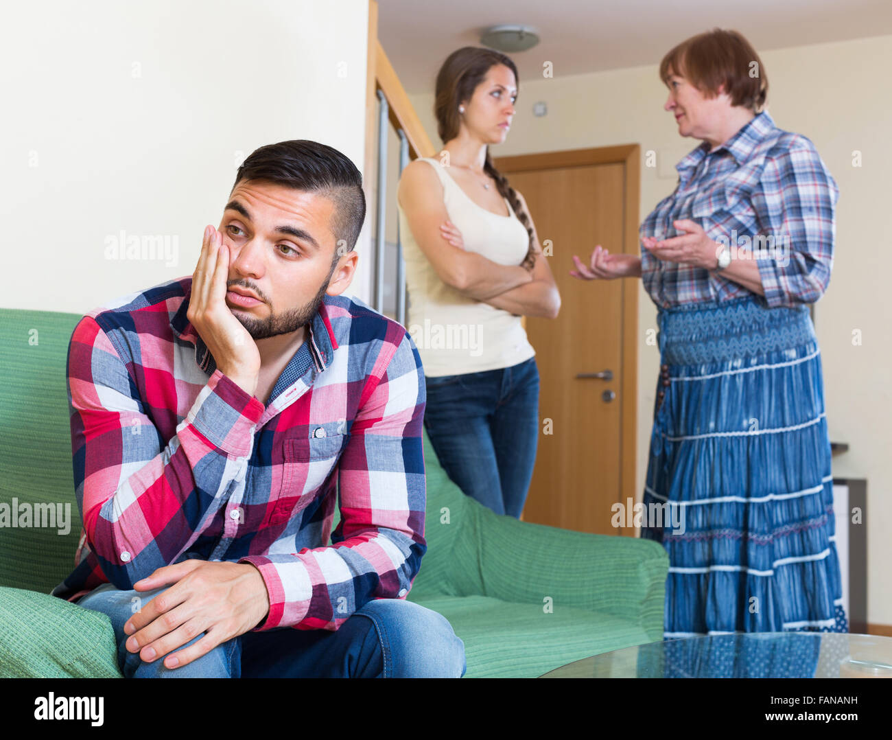 Conflict at home in young family with senior mother. Selective focus ...