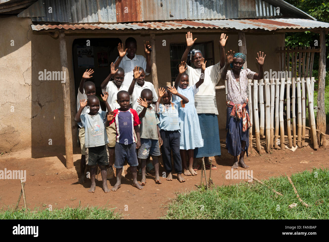 Happy family outside house in Kenya, waving and smiling Stock Photo - Alamy