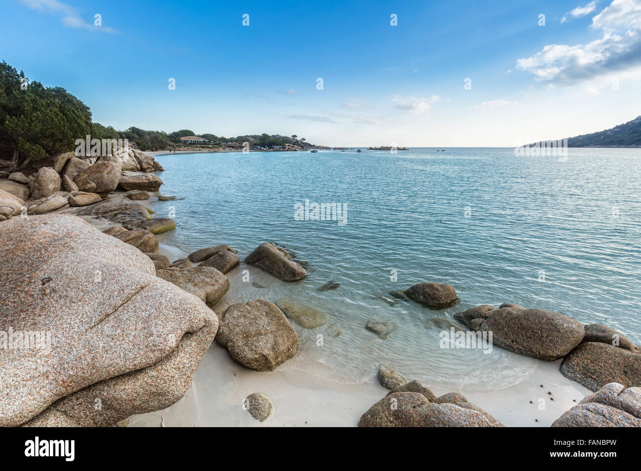 Rocks and boulders in a translucent turquoise sea and blue skies at ...