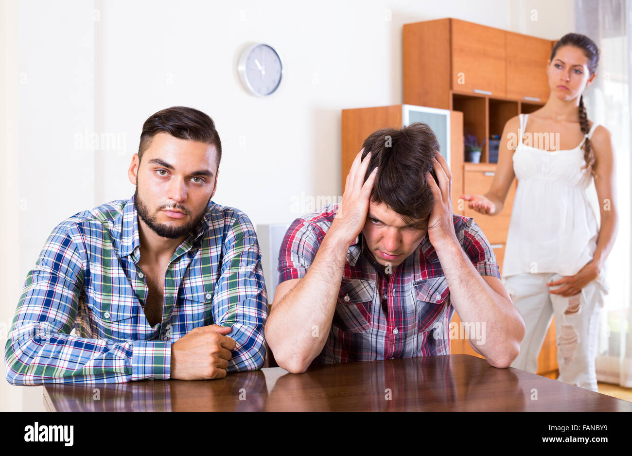 Young adults with sad faces at home: problems of love triangle Stock ...