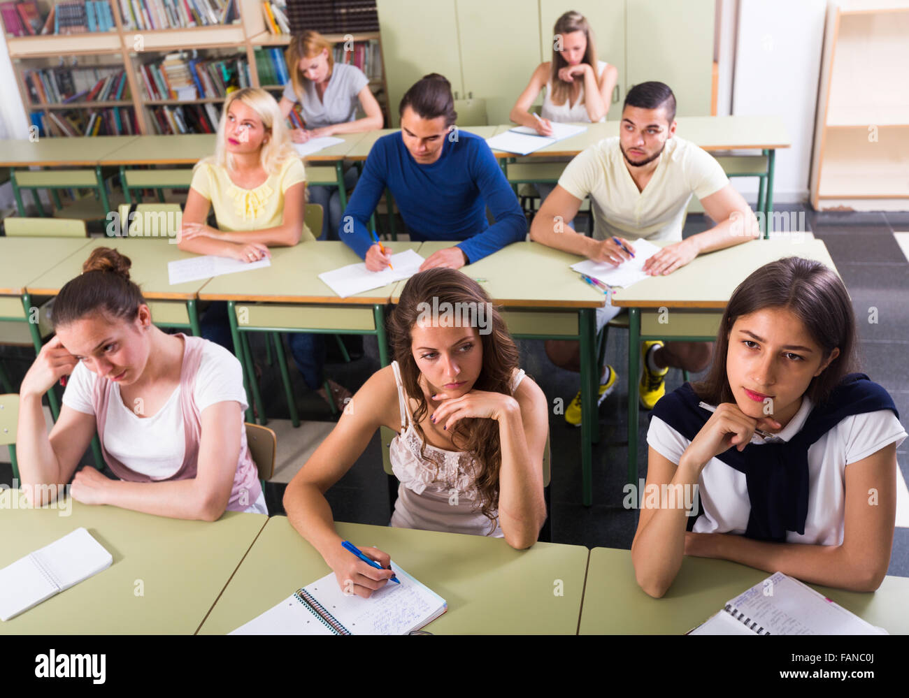 Group of young students studying together in classroom Stock Photo - Alamy