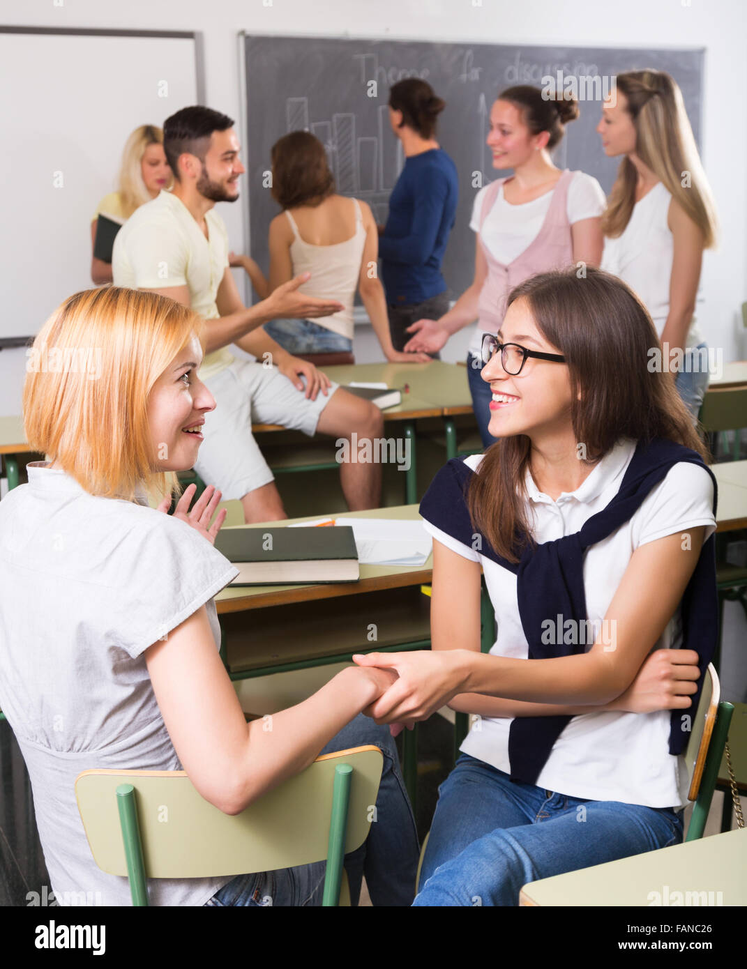 Several smiling students communication sitting in the classroom Stock ...
