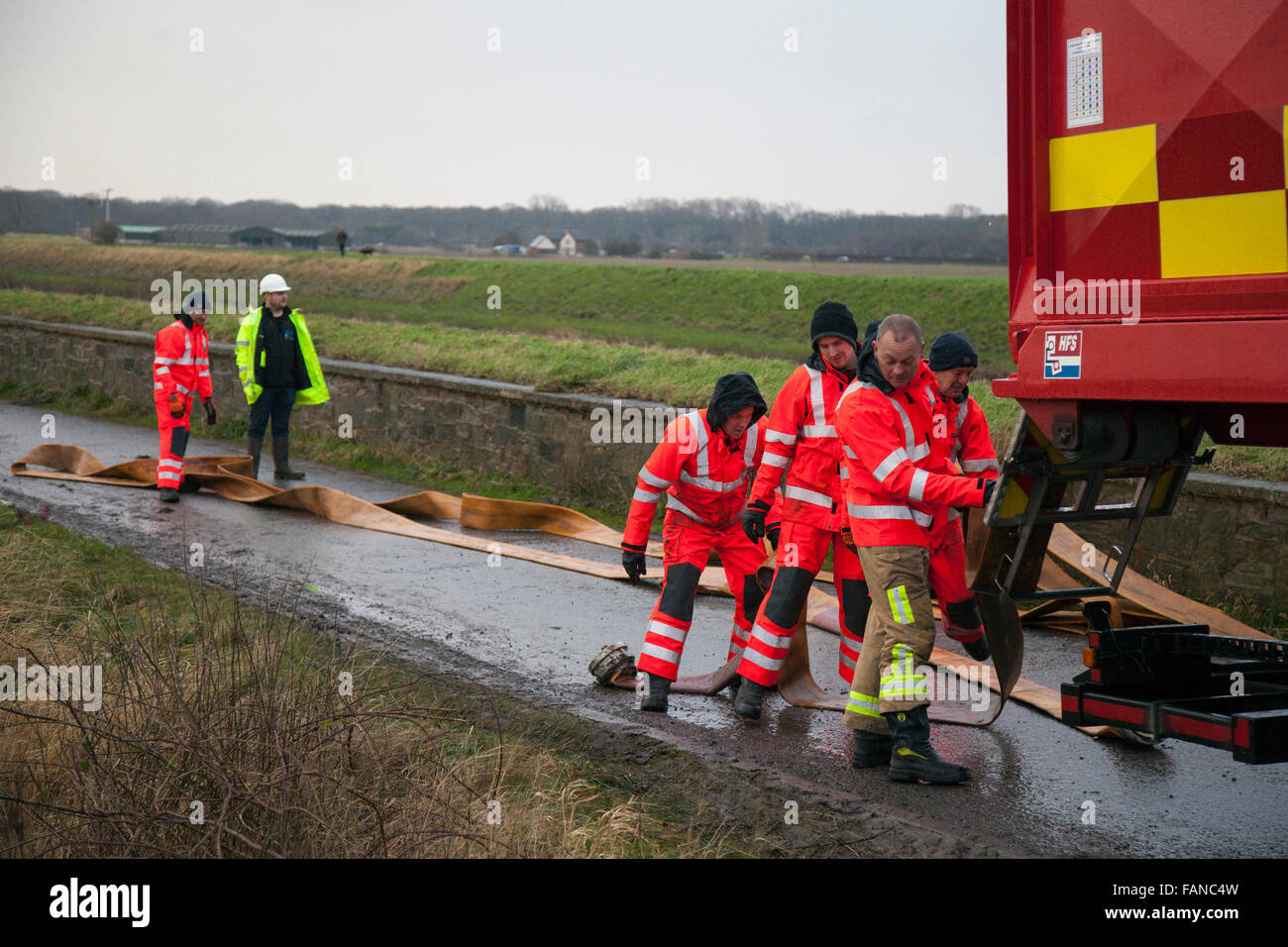 Huge pumps and fire hoses are being used to disperse the flood water ...