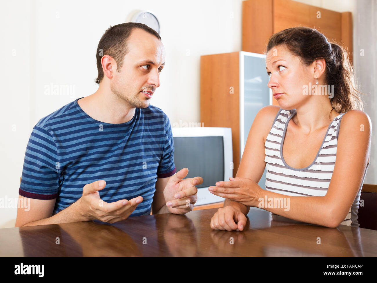 Family couple having serious conversation at home Stock Photo - Alamy