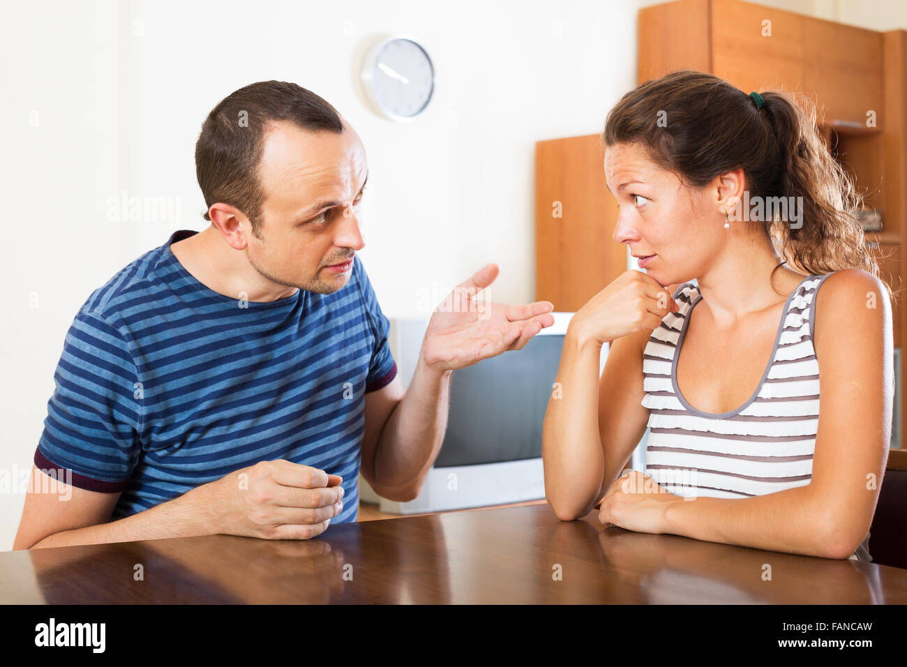 Family couple having serious conversation in home Stock Photo - Alamy