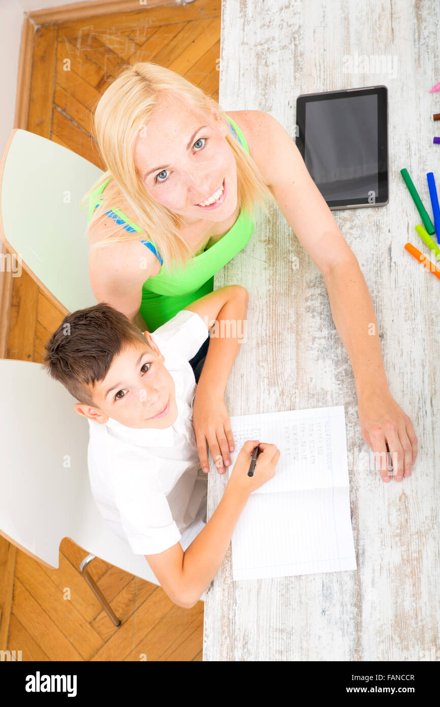 A mother helping his son with his homework Stock Photo - Alamy