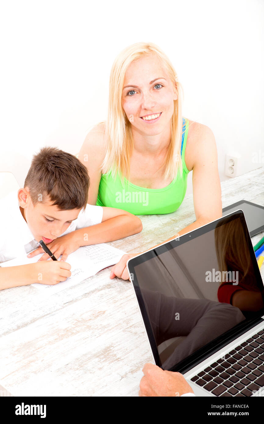A mother helping his son with his homework Stock Photo - Alamy