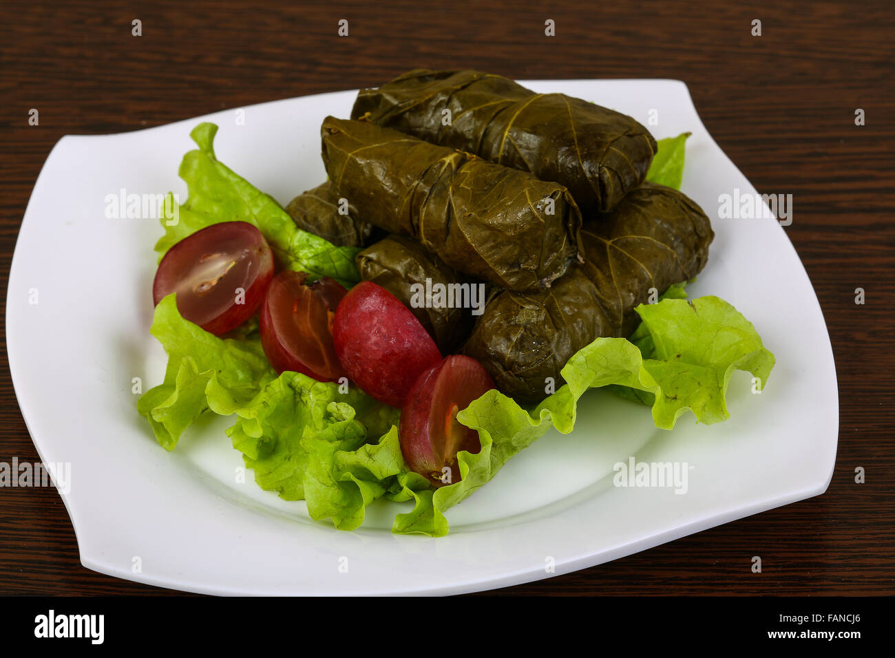 Dolma - minced meat in grape leaves with salad Stock Photo - Alamy