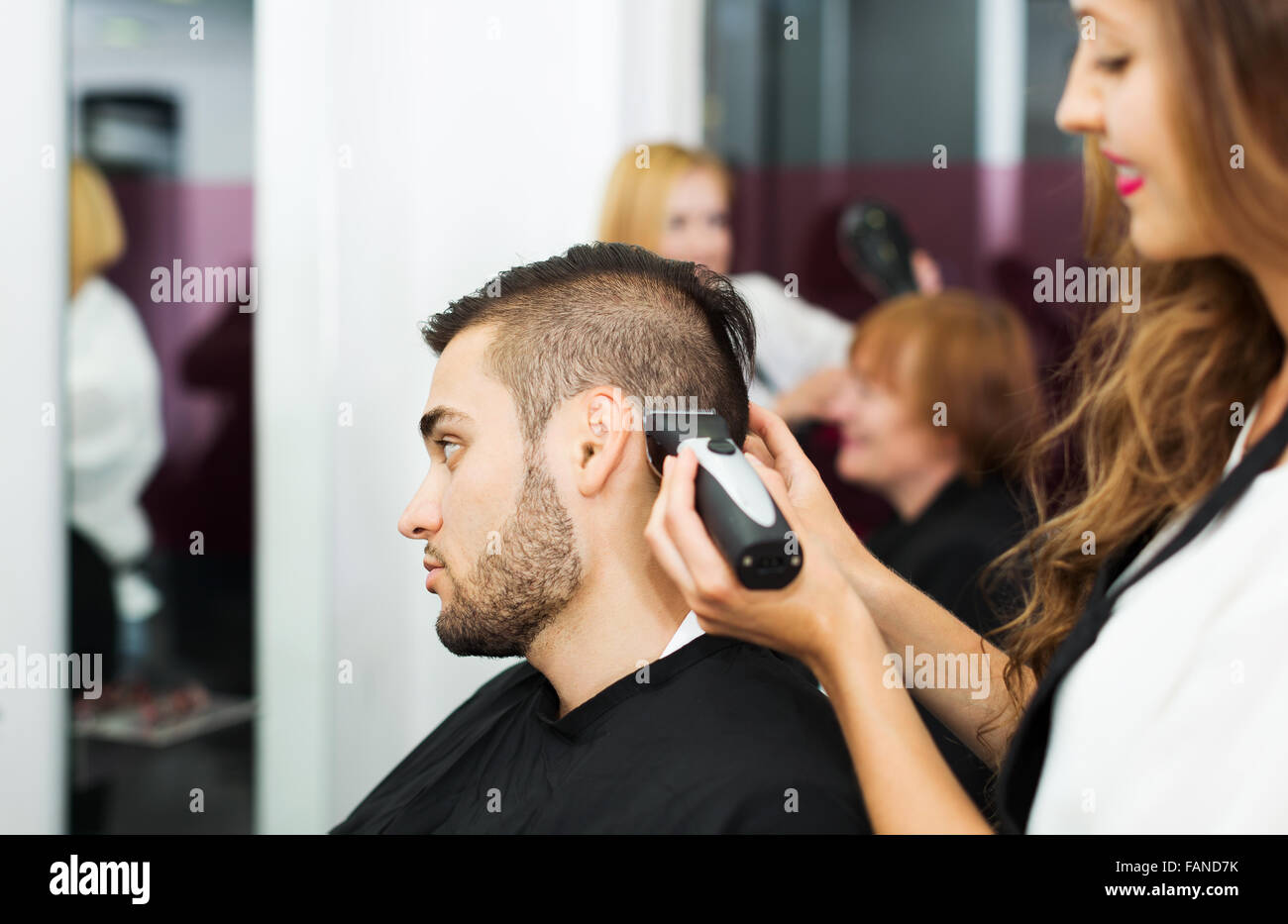 Haircutter makes the haircut for man in the hairdressing salon Stock ...