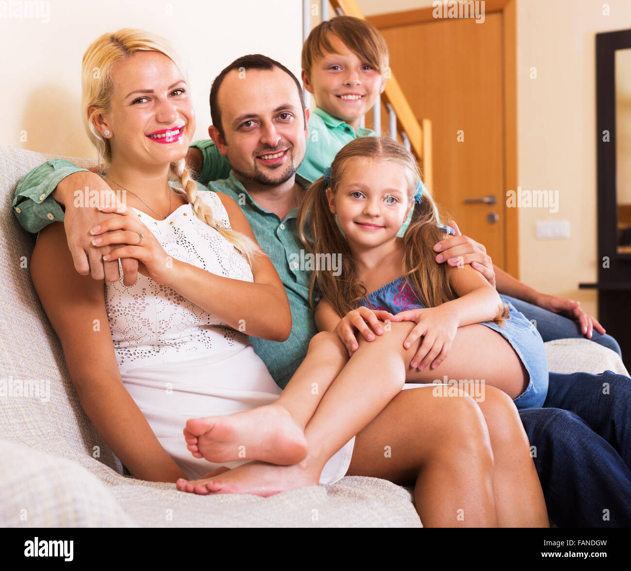 Portrait of happy middle class family at home. Focus on woman Stock ...