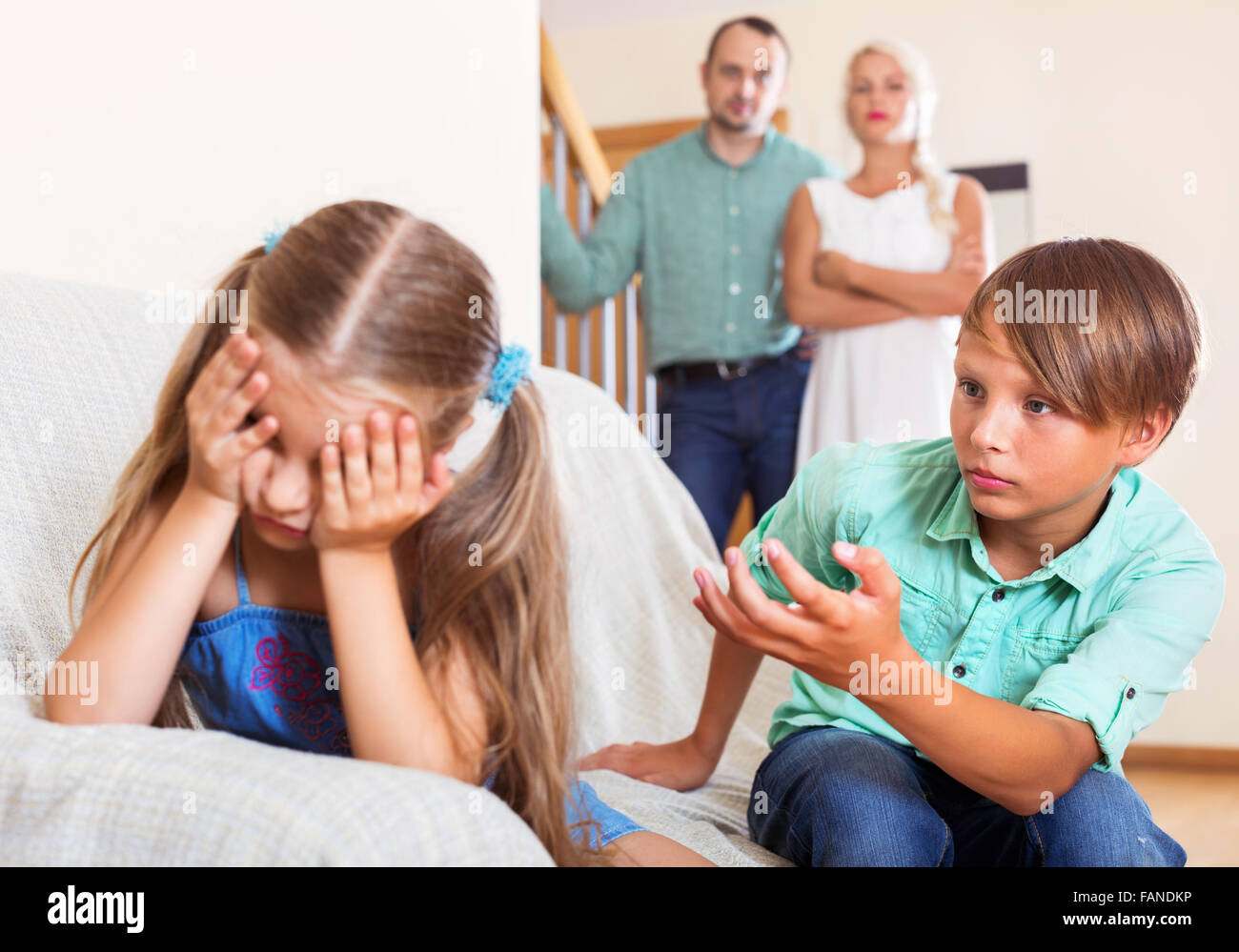 Brother is talking to her sister crying in the presence of parents at ...