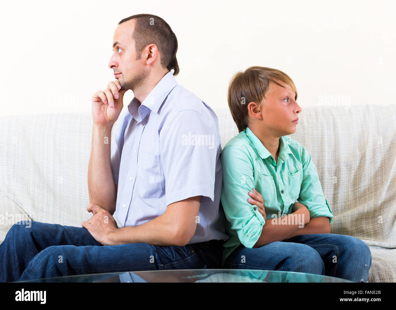 Tired adult man and frustrated young son having quarrel at home Stock ...