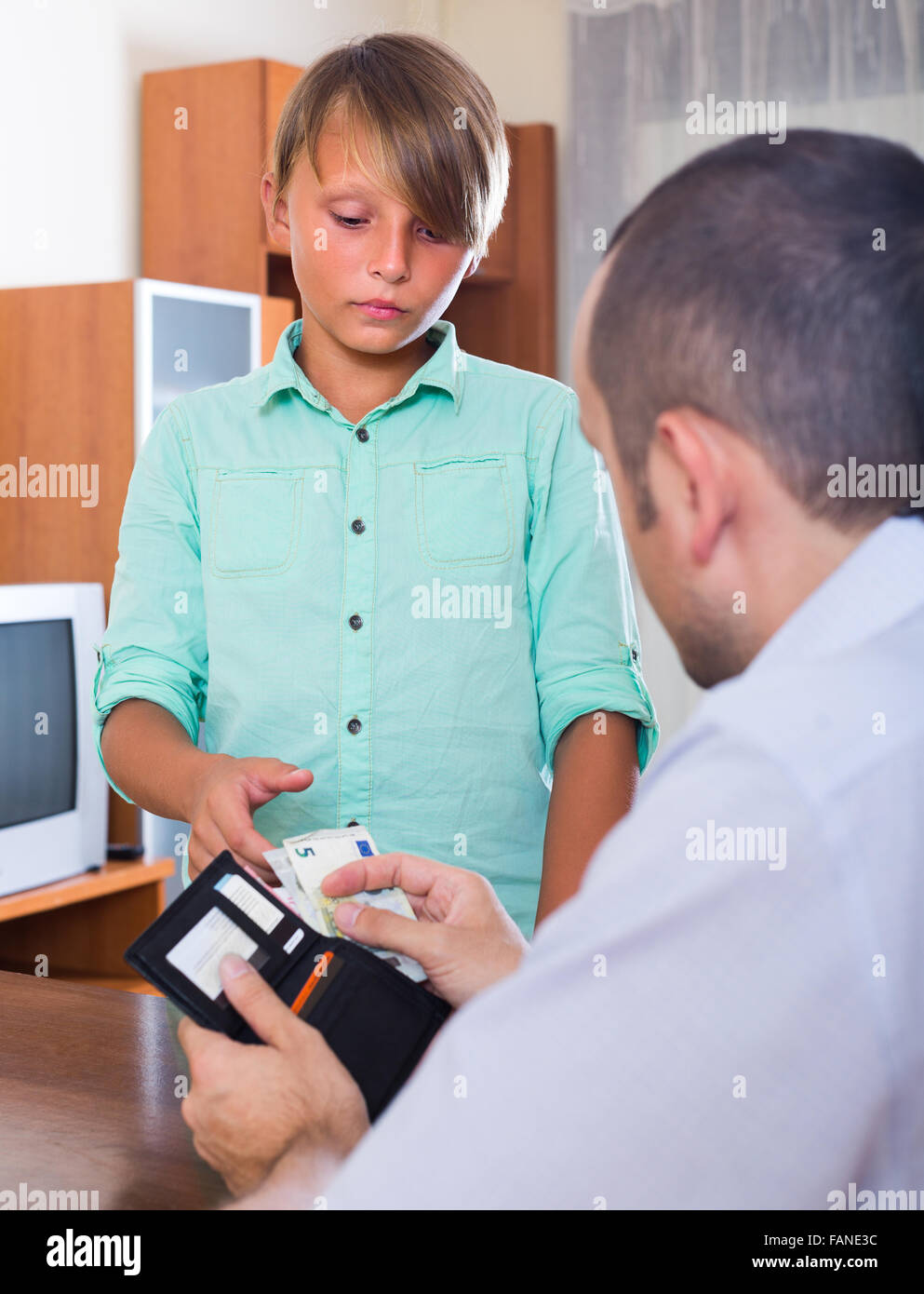 Boy asking father for small pocket money at home Stock Photo - Alamy